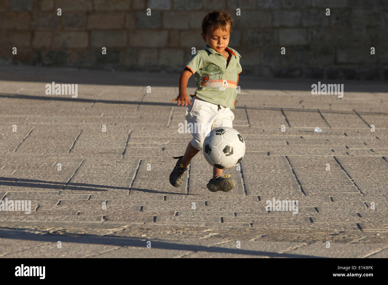 Child playing football Stock Photo - Alamy