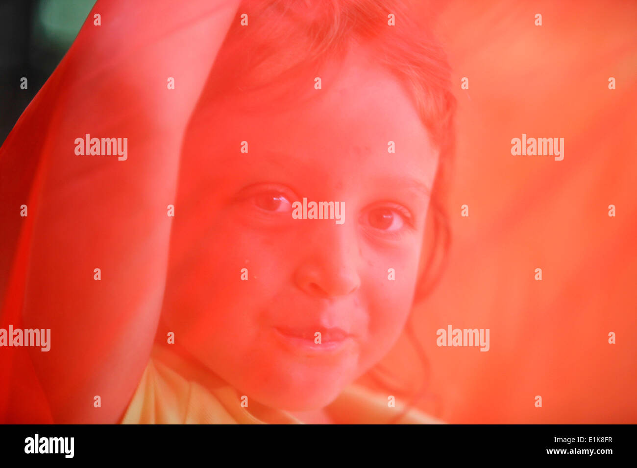 Child playing with red cloth Stock Photo - Alamy