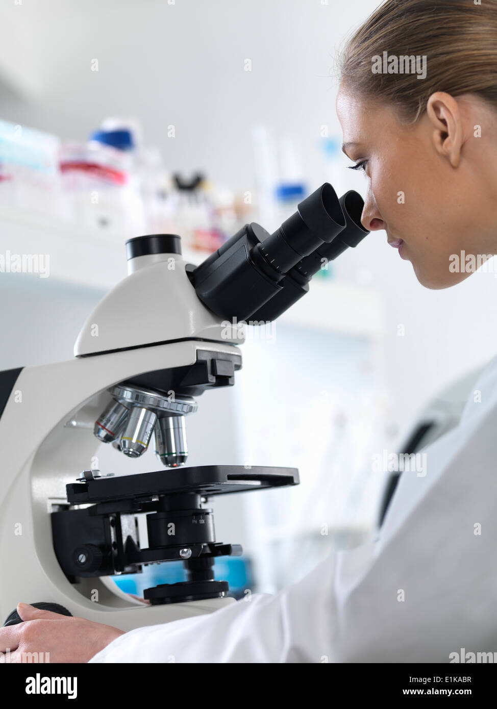 Female scientist using a microscope Stock Photo - Alamy