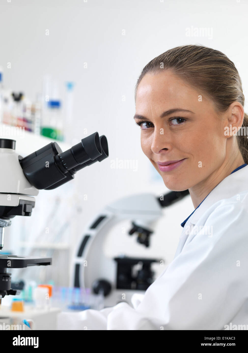 Portrait of female scientist by a microscope Stock Photo - Alamy