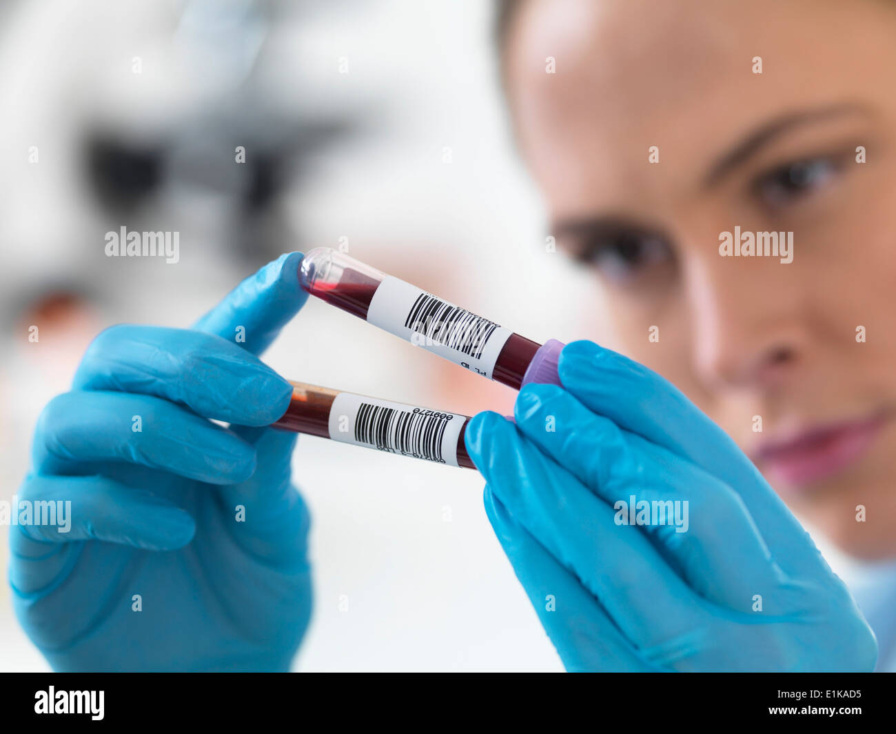 Female scientist holding blood samples in test tubes Stock Photo - Alamy