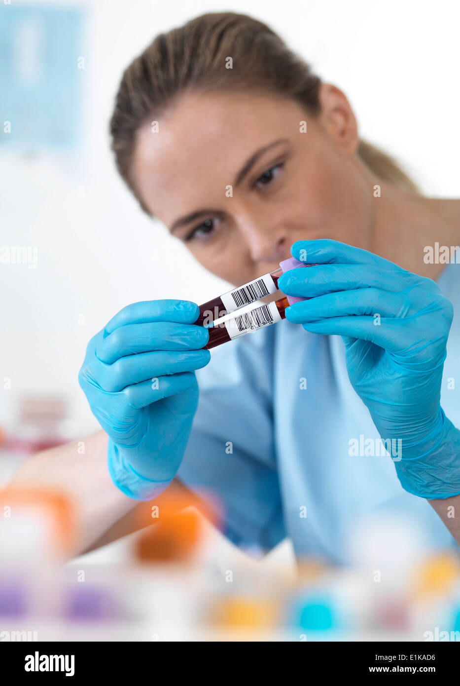 Female scientist holding blood samples in test tubes Stock Photo - Alamy