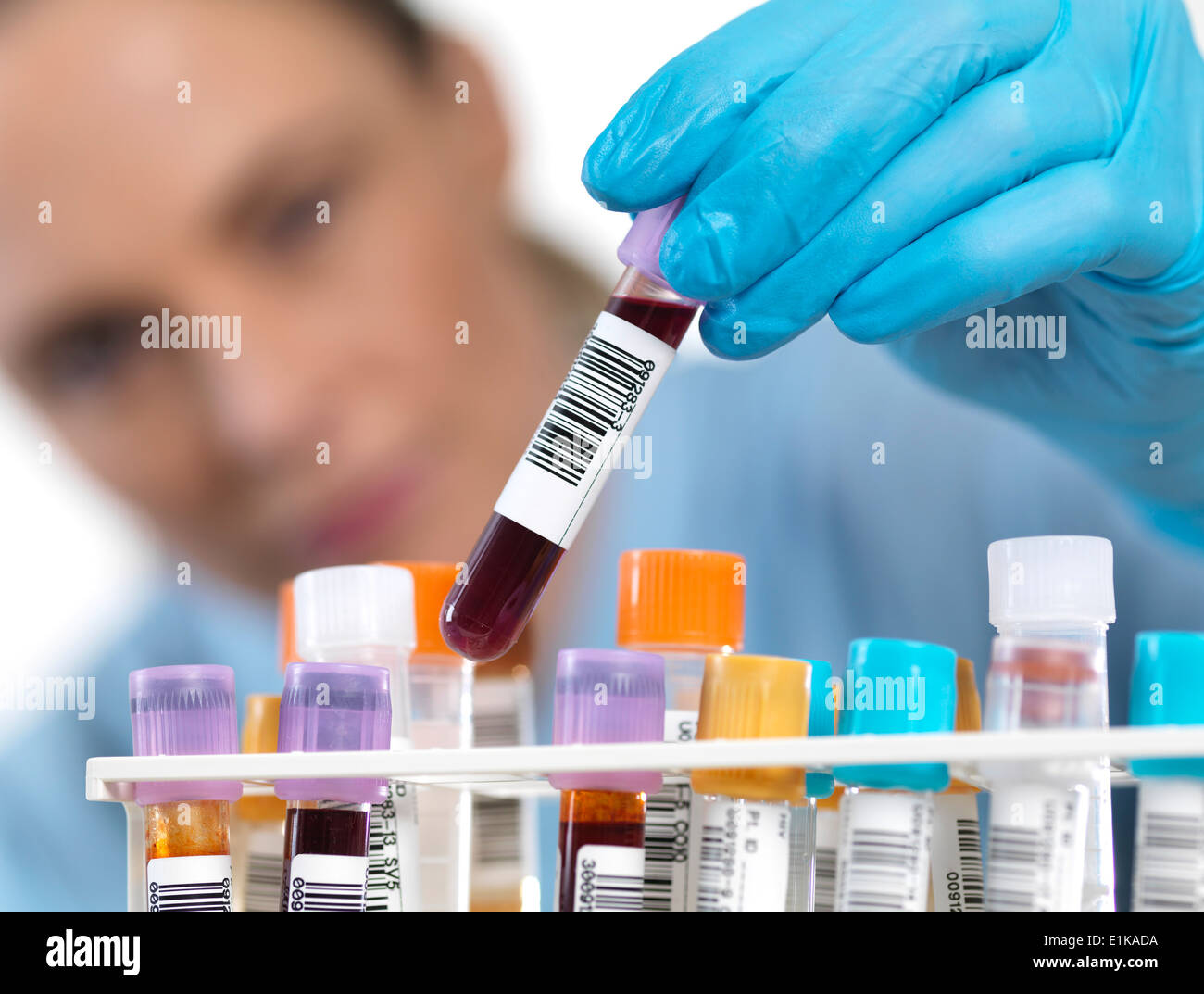 Scientist holding blood sample in a test tube rack Stock Photo - Alamy