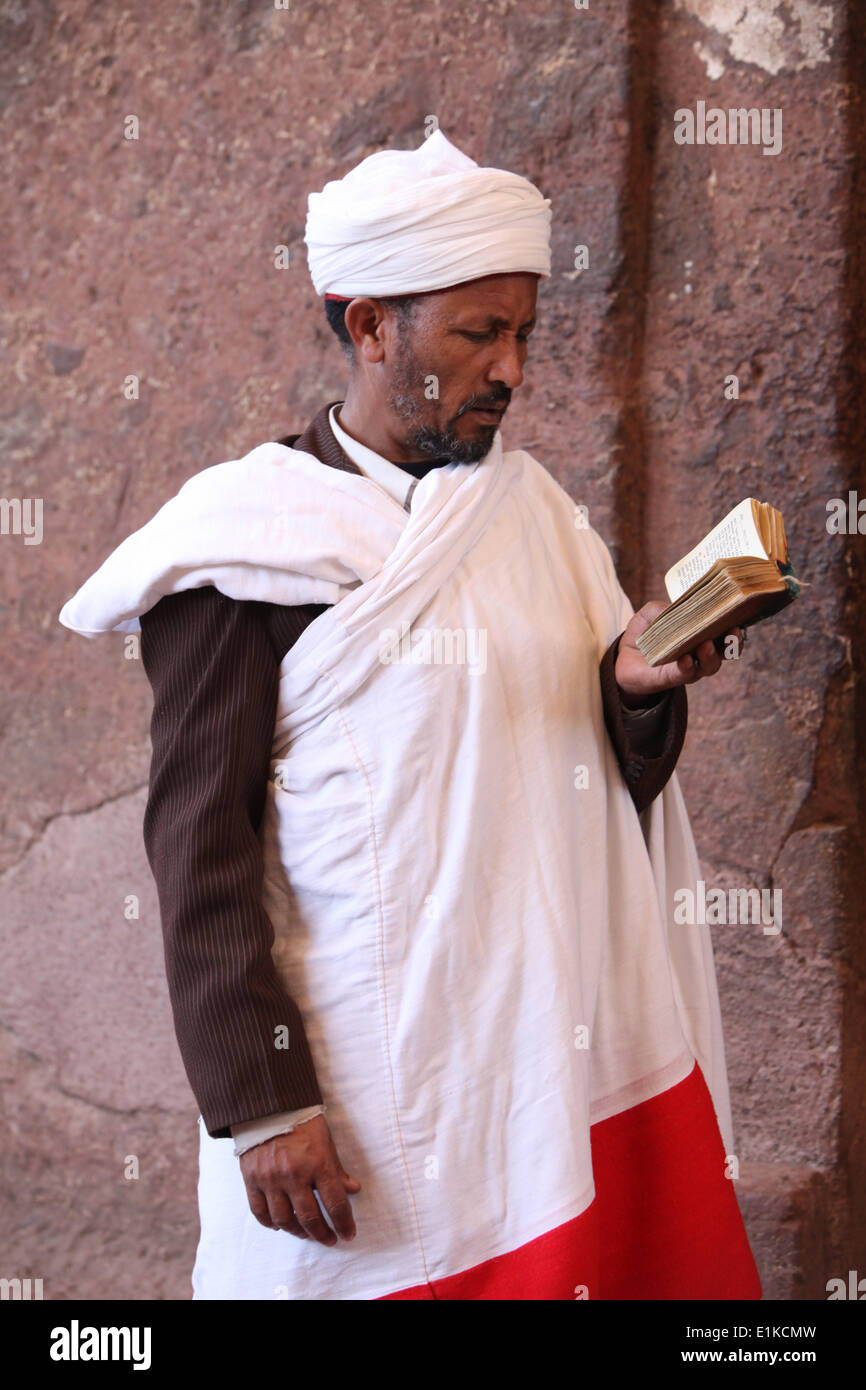 Priest reading outside Bieta Maskal church, Lalibela Stock Photo - Alamy