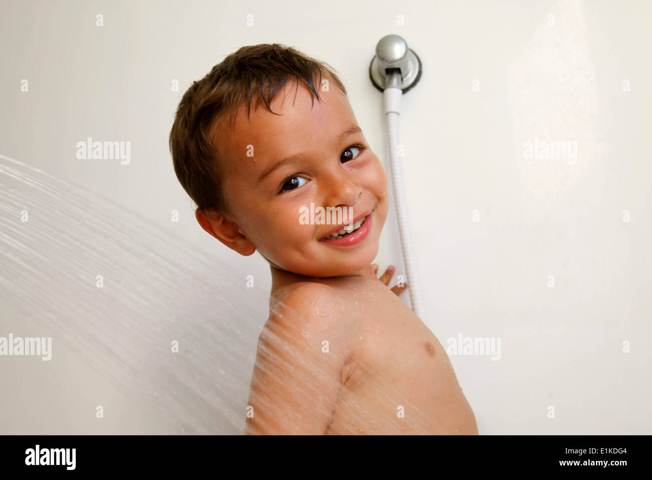 Boy having a shower Stock Photo - Alamy