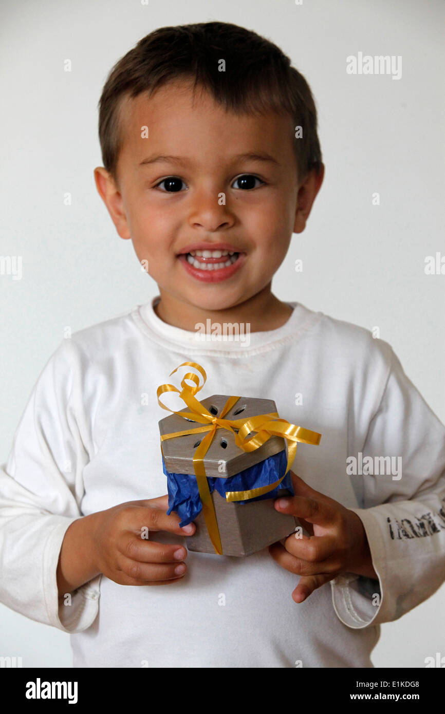Boy holding a present Stock Photo - Alamy