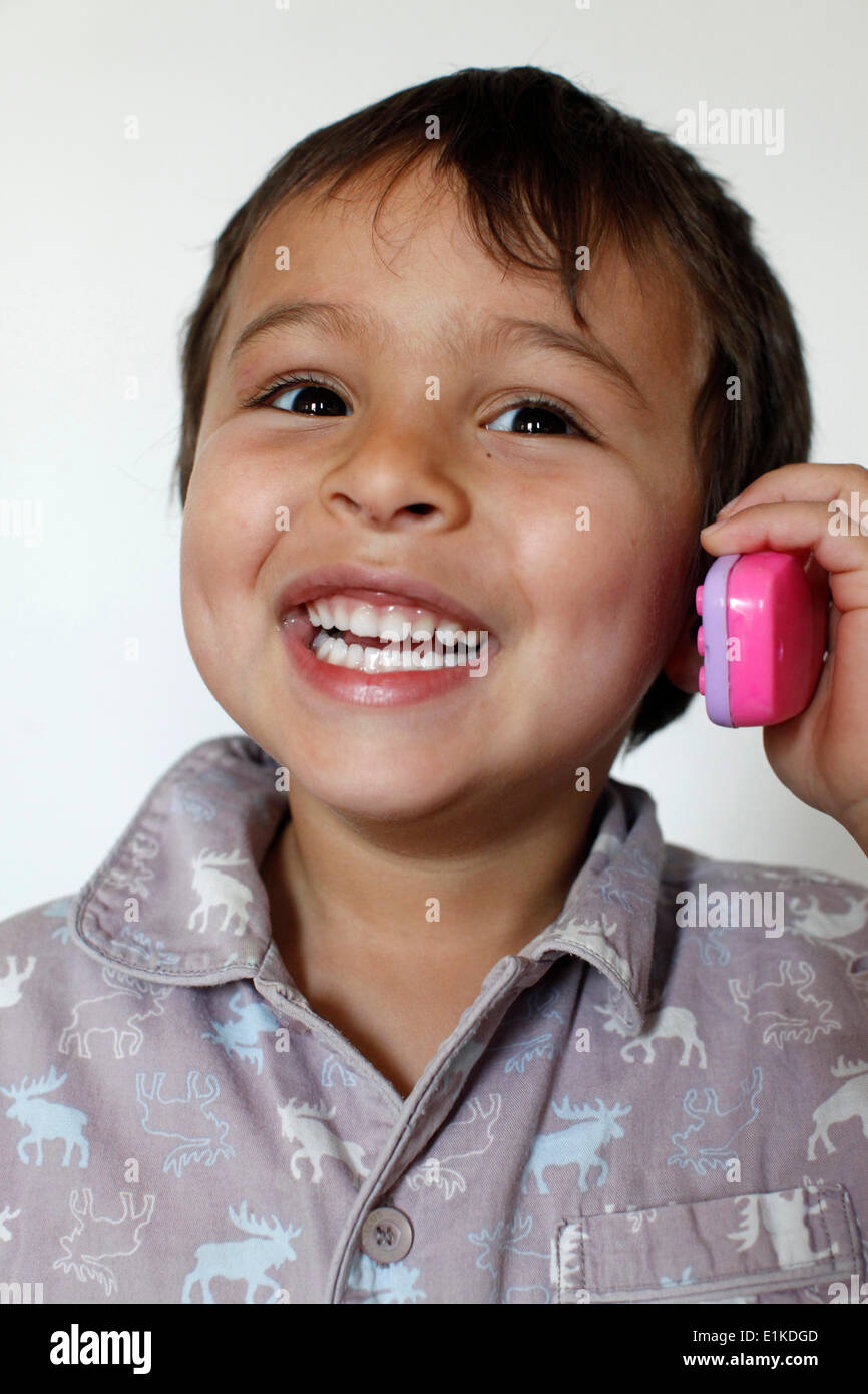 Boy playing with a toy cell phone Stock Photo - Alamy