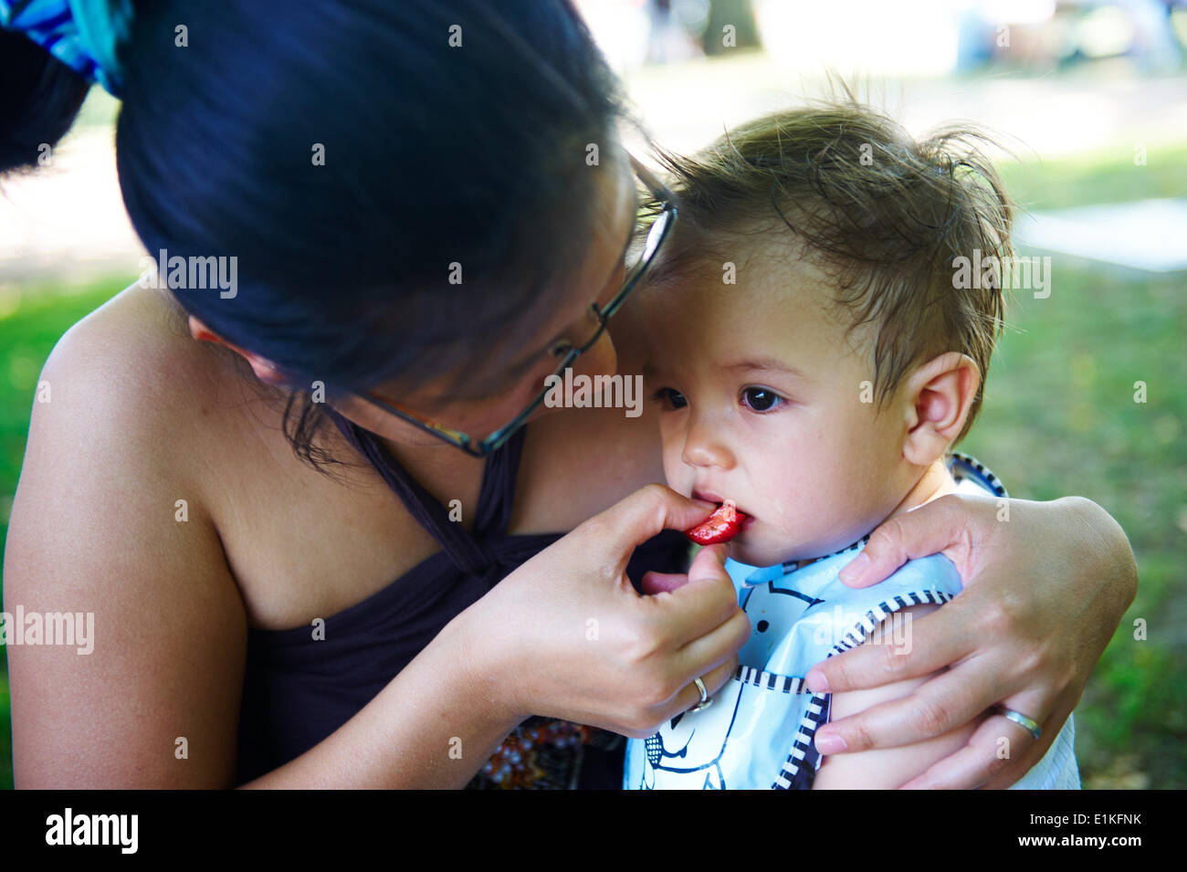 Mother feeding her child Stock Photo - Alamy