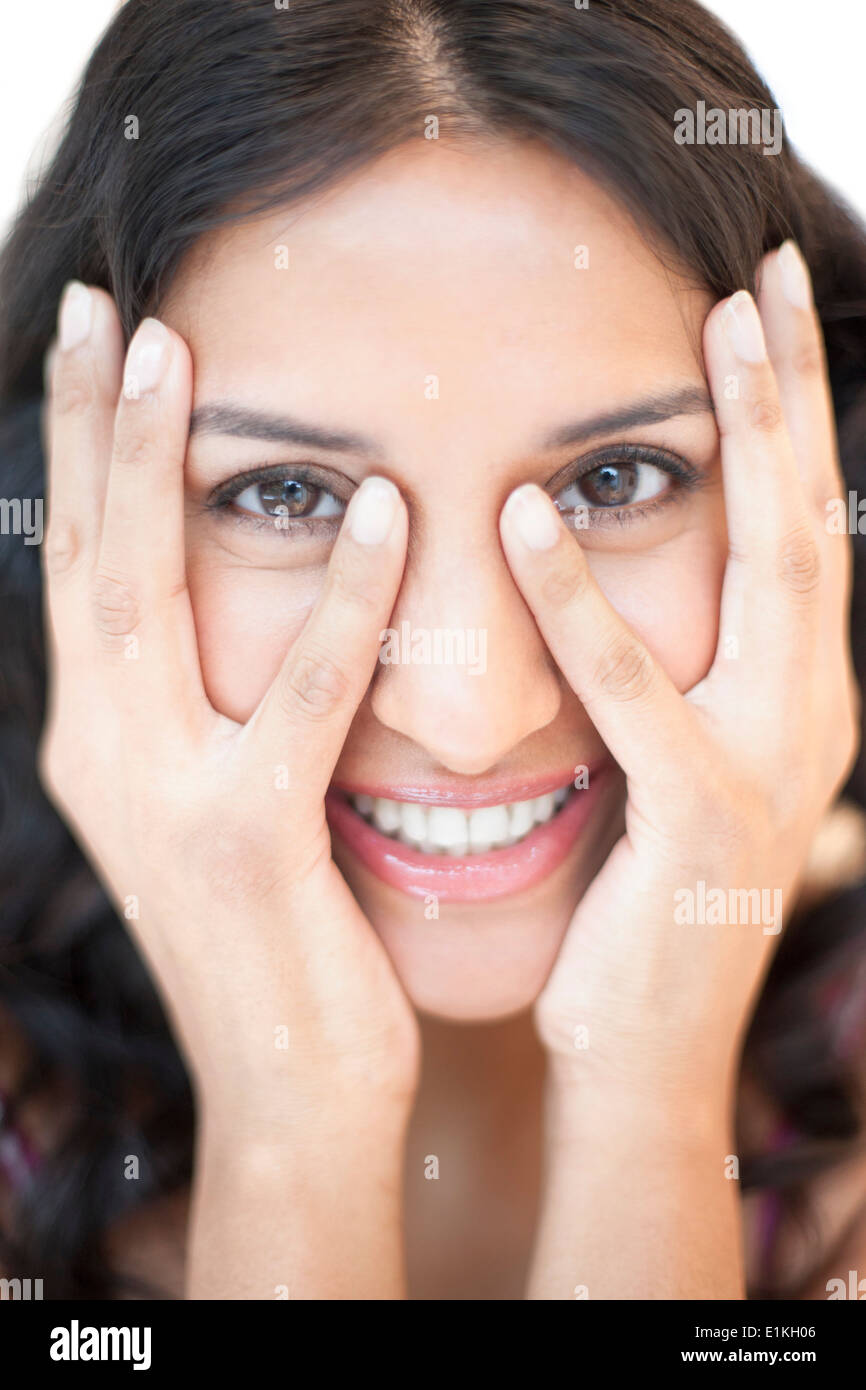 MODEL RELEASED Portrait of a woman with her hands touching her face ...