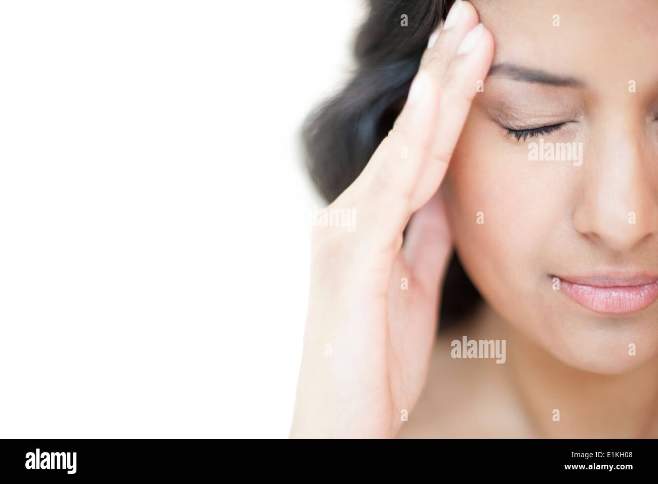 MODEL RELEASED Portrait of a woman touching her head with her eyes ...