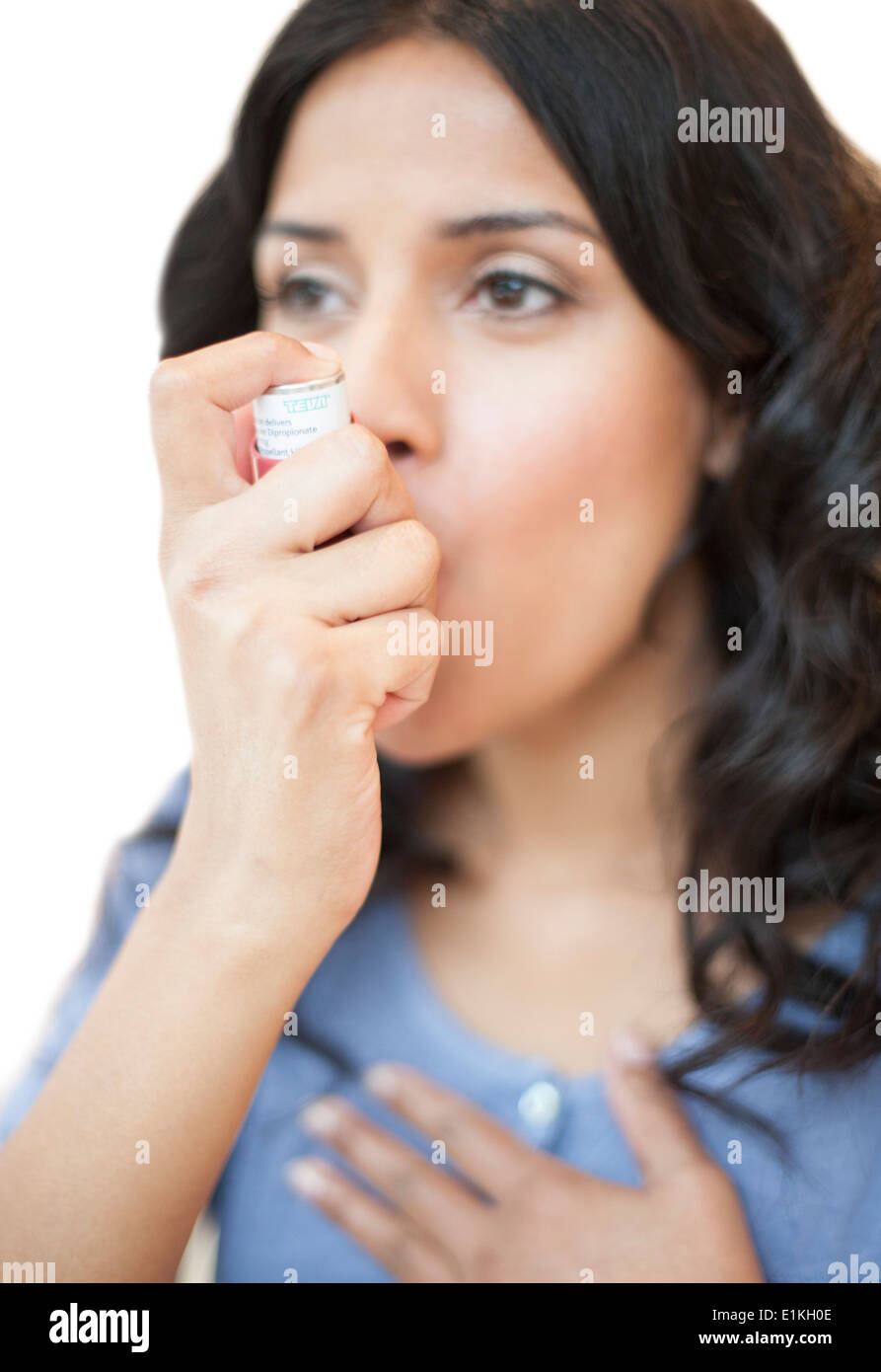 MODEL RELEASED Woman using an inhaler Stock Photo - Alamy