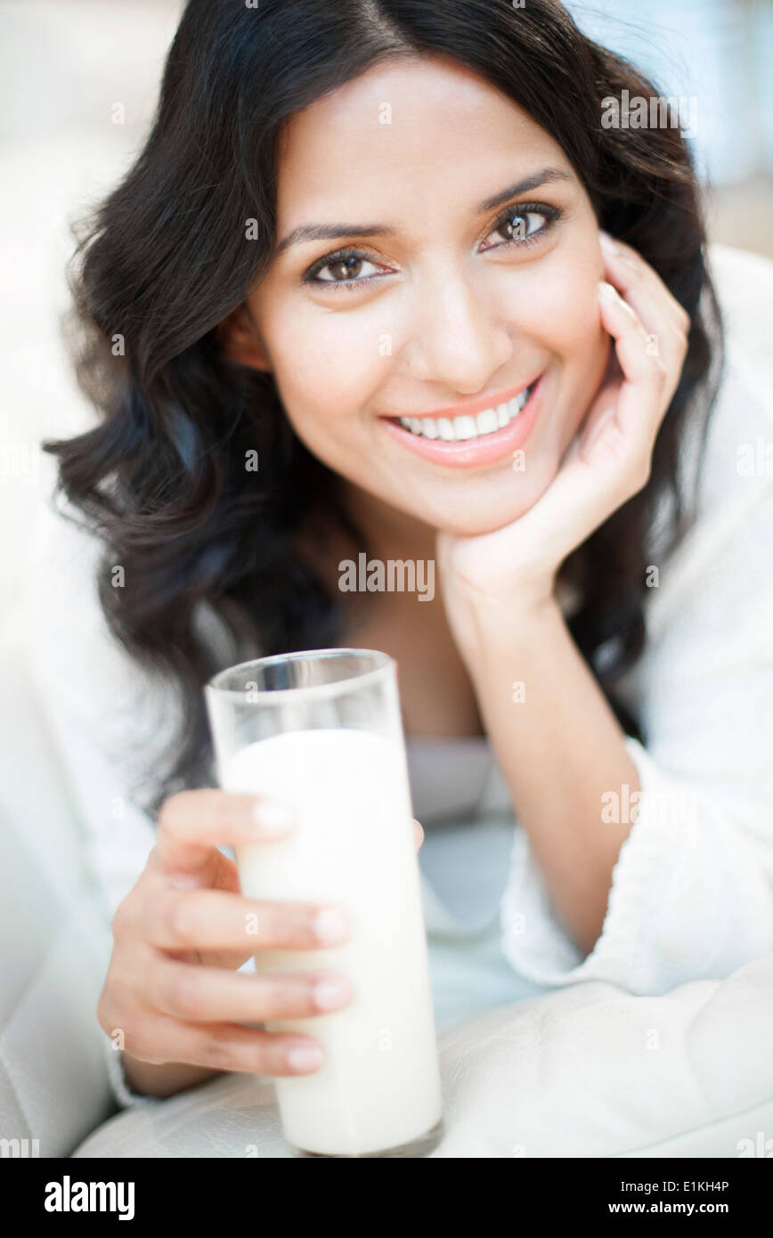MODEL RELEASED Portrait of a woman holding a glass of milk Stock Photo ...