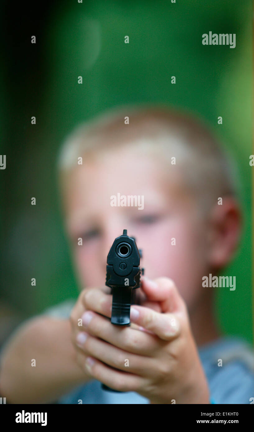 Boy with toy pistol Stock Photo - Alamy