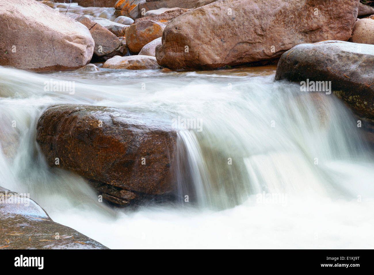 Waterfall flowing over rocks close up Stock Photo - Alamy