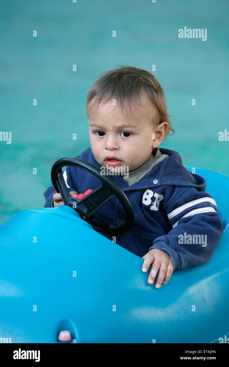 Baby in a toy car Stock Photo - Alamy