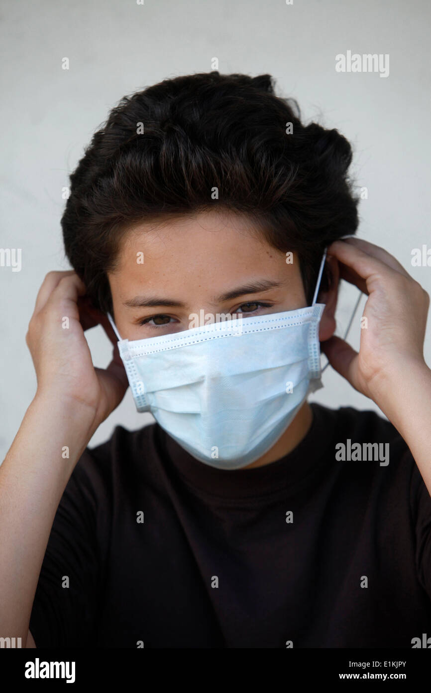 Boy putting on a protection mask Stock Photo - Alamy
