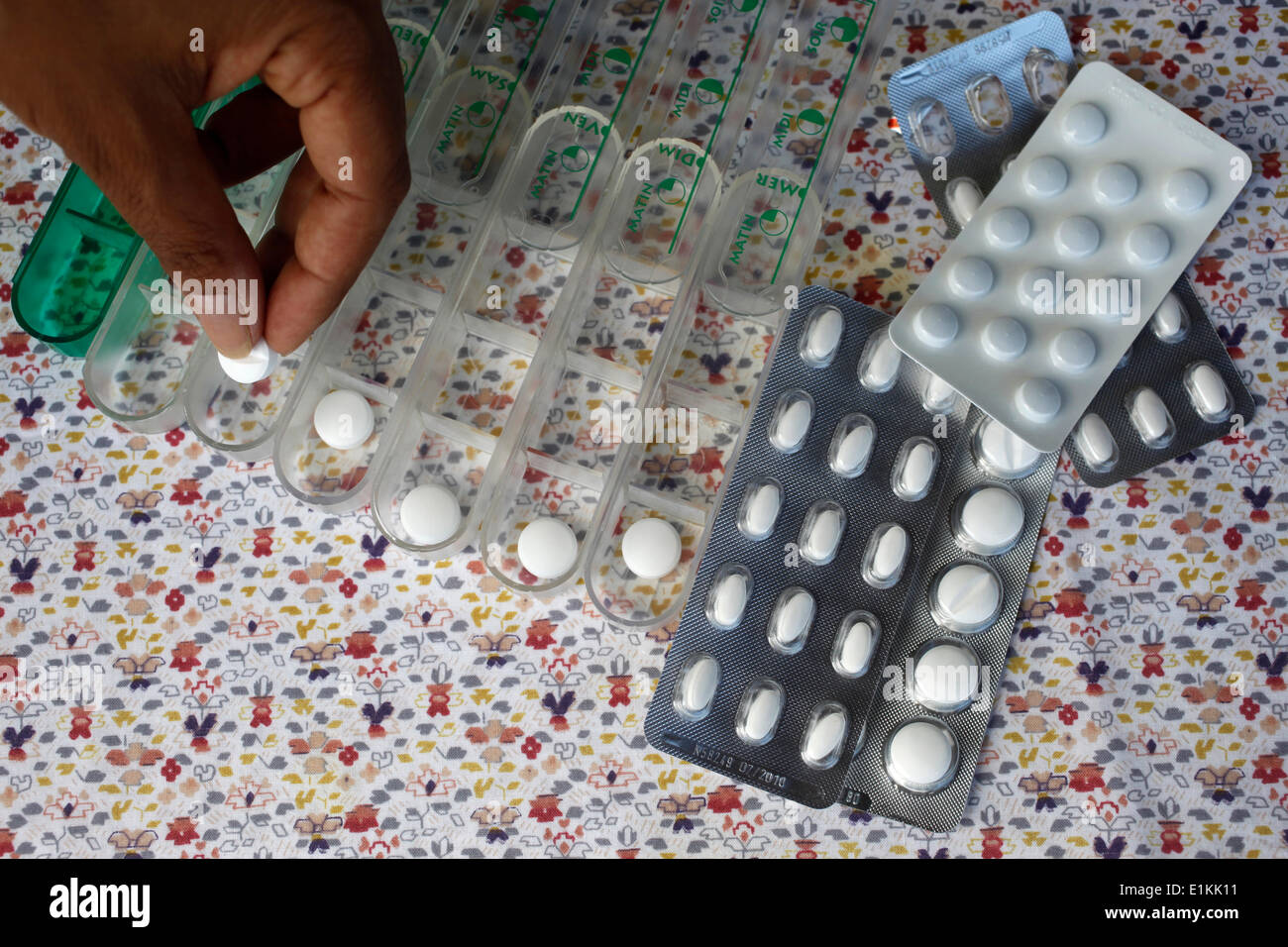 Home help filling an elderly person's pill box Stock Photo - Alamy