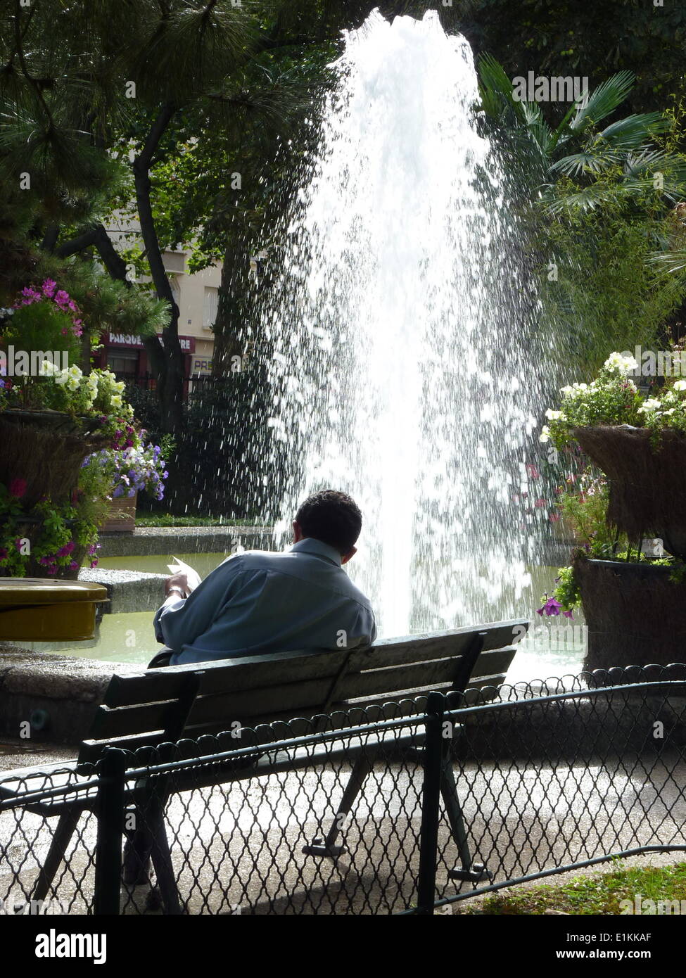 Man sitting on a park bench in Paris Stock Photo - Alamy