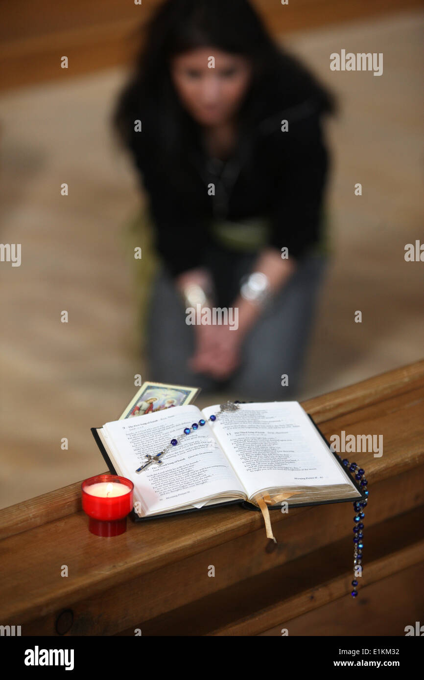 Woman praying in a church Stock Photo - Alamy