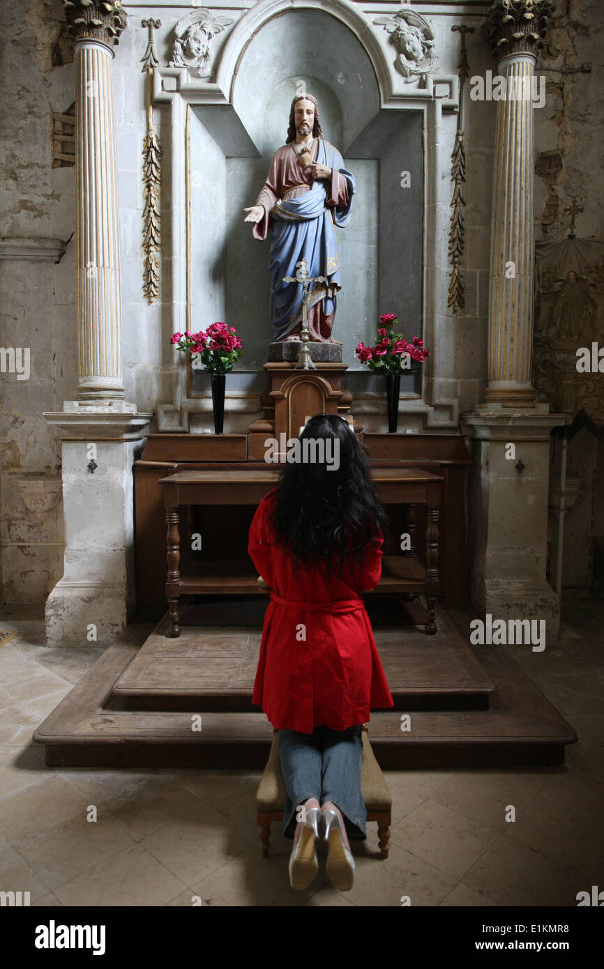 Woman praying in a church Stock Photo - Alamy