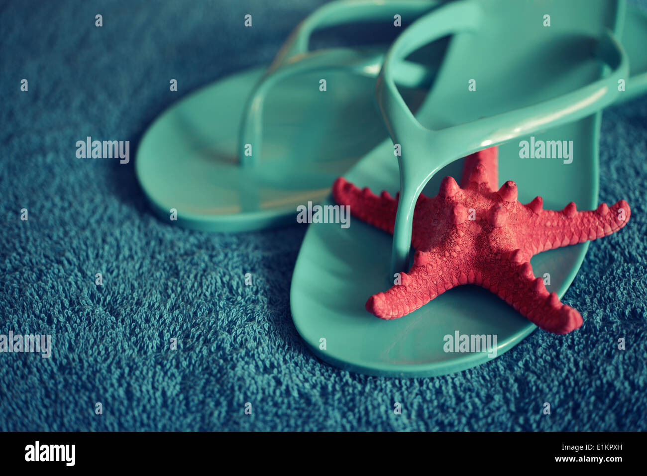 Vacation Concept. Blue Flip-flops with red starfish on towel closeup ...