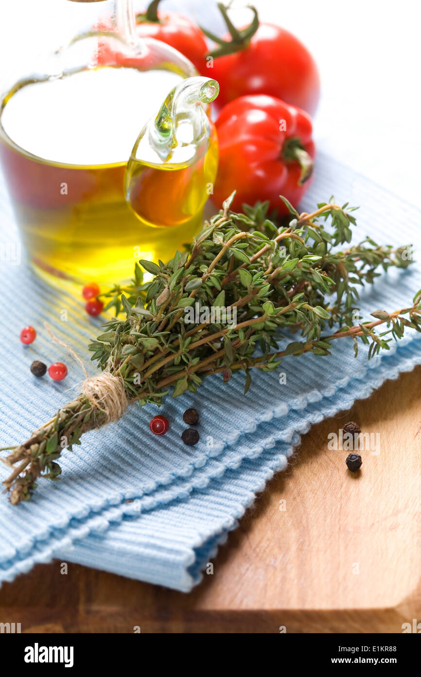 Bottle of Olive oil and condiments on blue napkin Stock Photo - Alamy