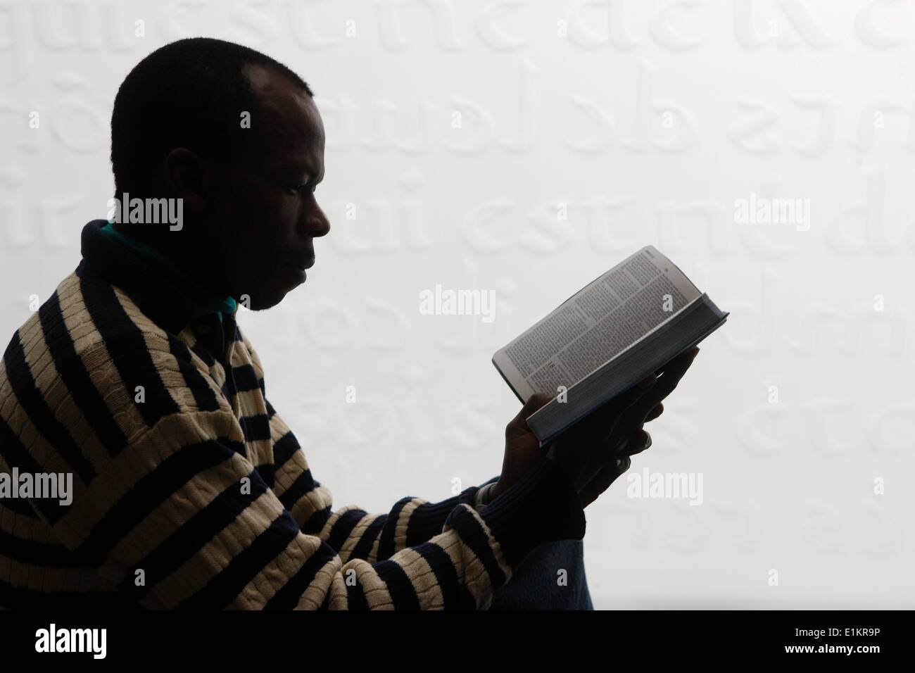 African man reading the bible in a church Stock Photo - Alamy