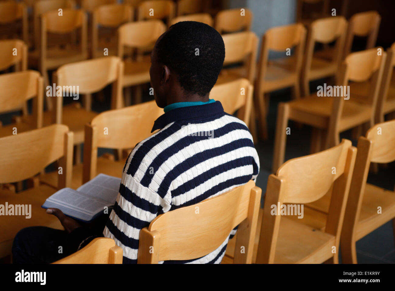 African man reading the bible in a church Stock Photo - Alamy
