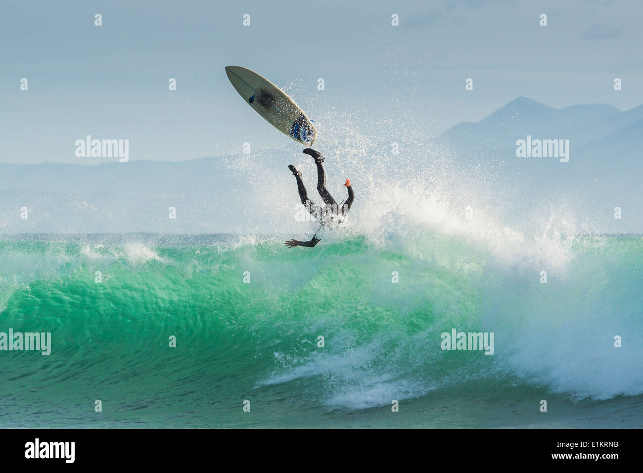 Surfer wiping out Stock Photo - Alamy