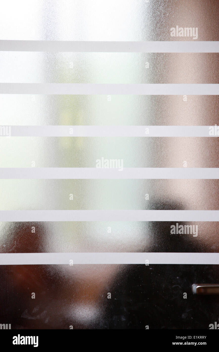 Figures behind a window Stock Photo - Alamy