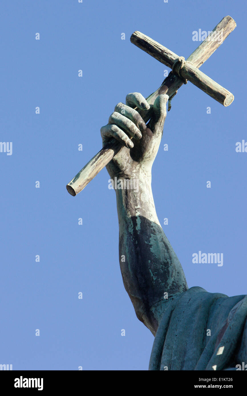 Sculpture detail : hand holding a cross Stock Photo - Alamy