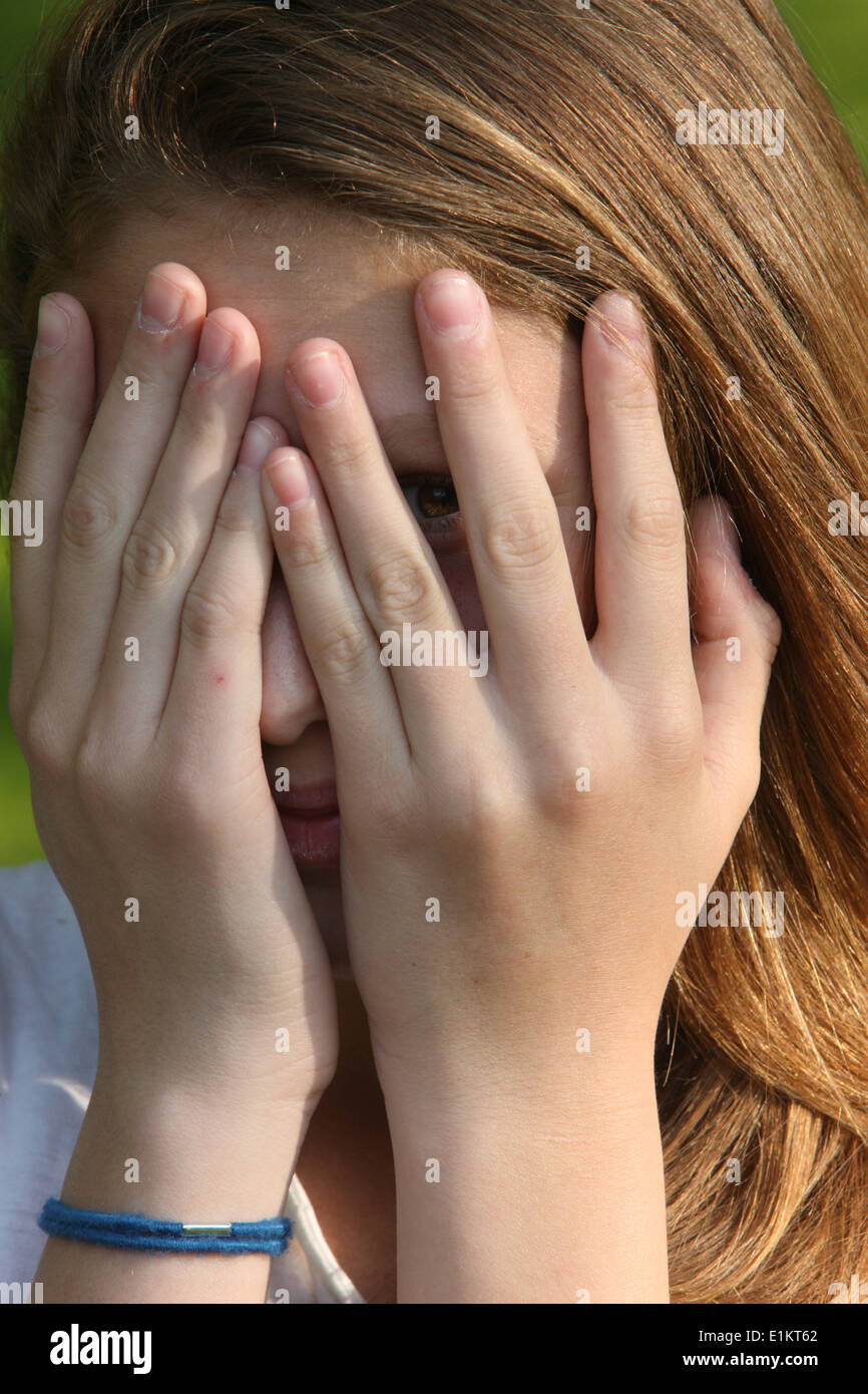 Girl hiding her face Stock Photo - Alamy