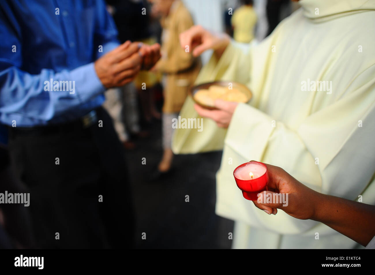 Catholic priest giving holy communion Stock Photo - Alamy