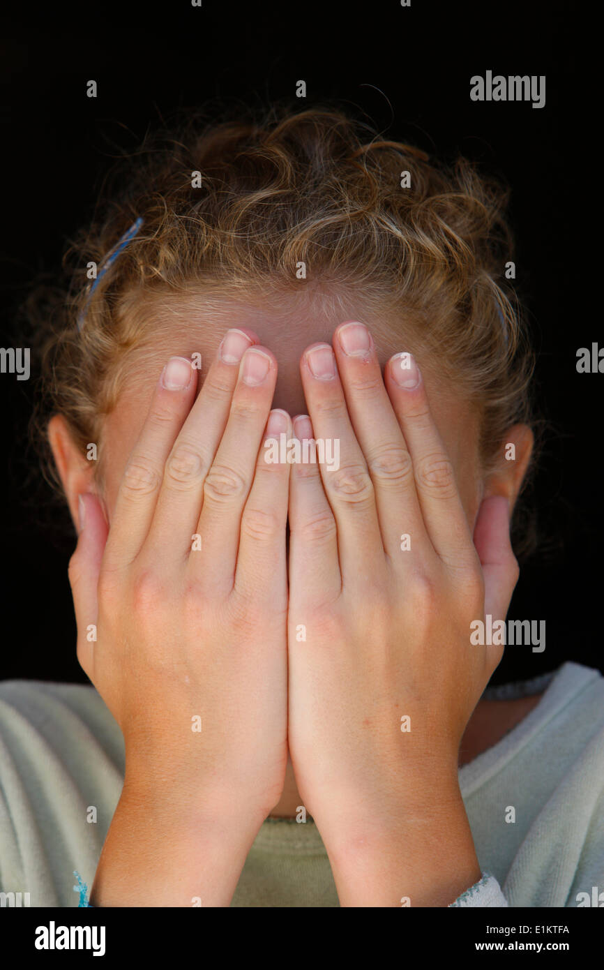 Girl hiding her face Stock Photo - Alamy