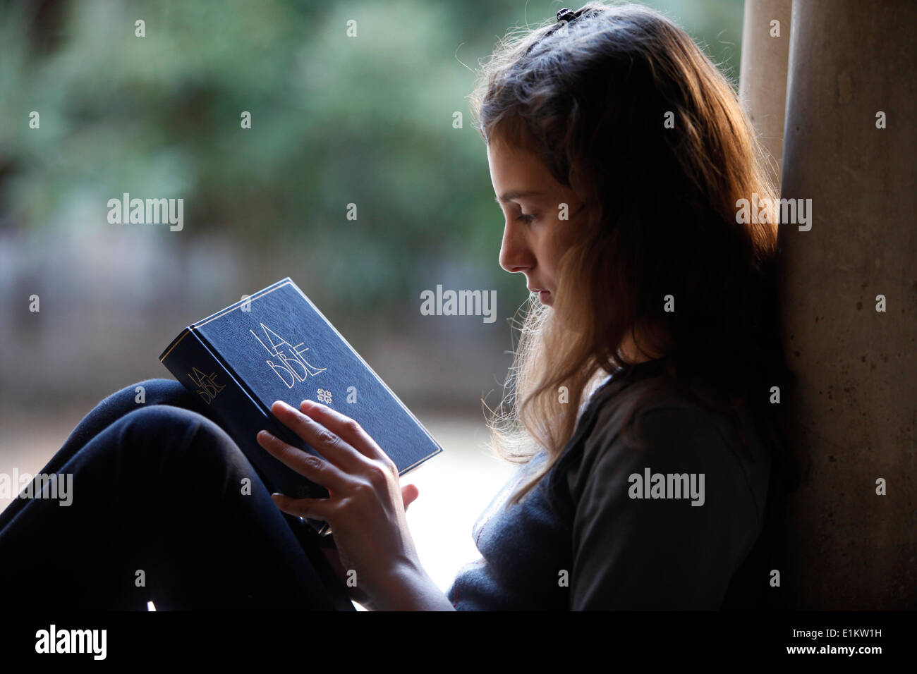 Girl opening a Bible Stock Photo - Alamy