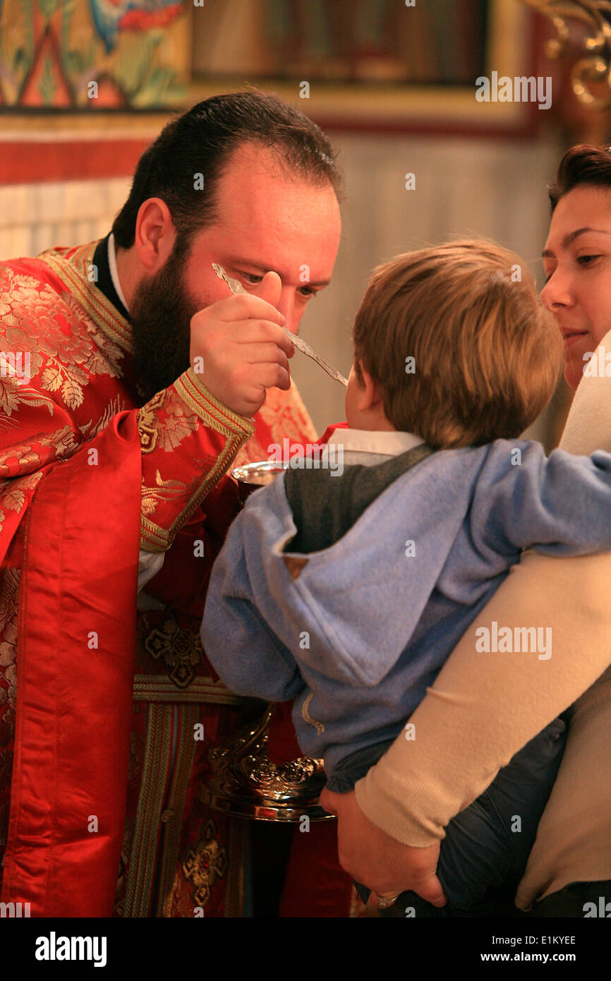 Greek orthodox boy receiving the eucharist Stock Photo - Alamy