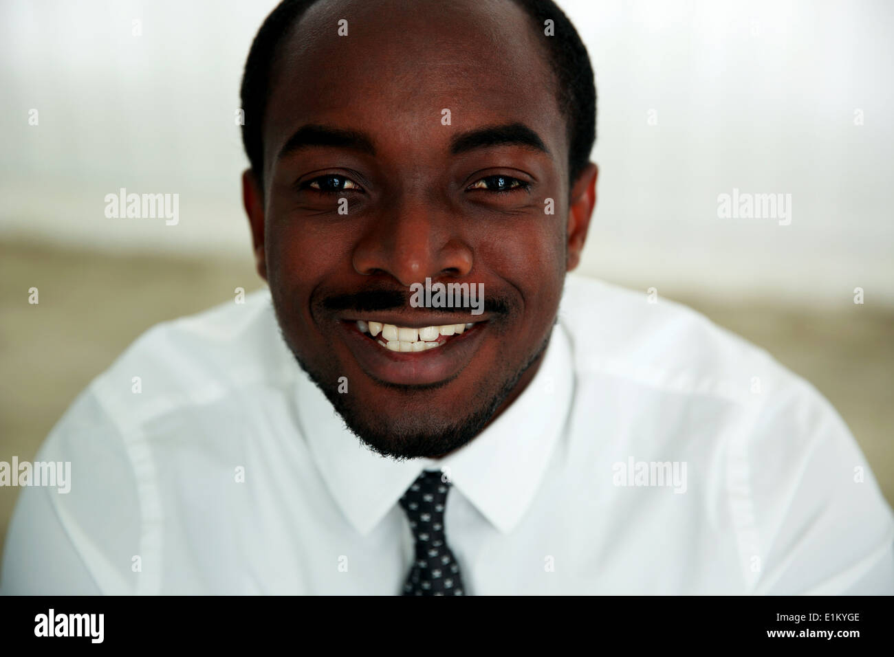 Portrait of a smiling african man in office Stock Photo - Alamy