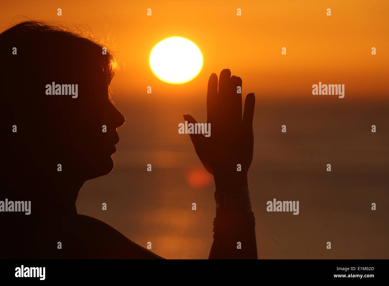 Woman Praying At Sunset High Resolution Stock Photography and Images ...