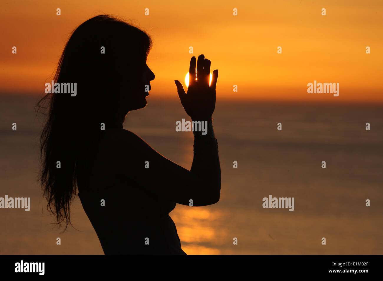 Woman Praying At Sunset High Resolution Stock Photography and Images ...