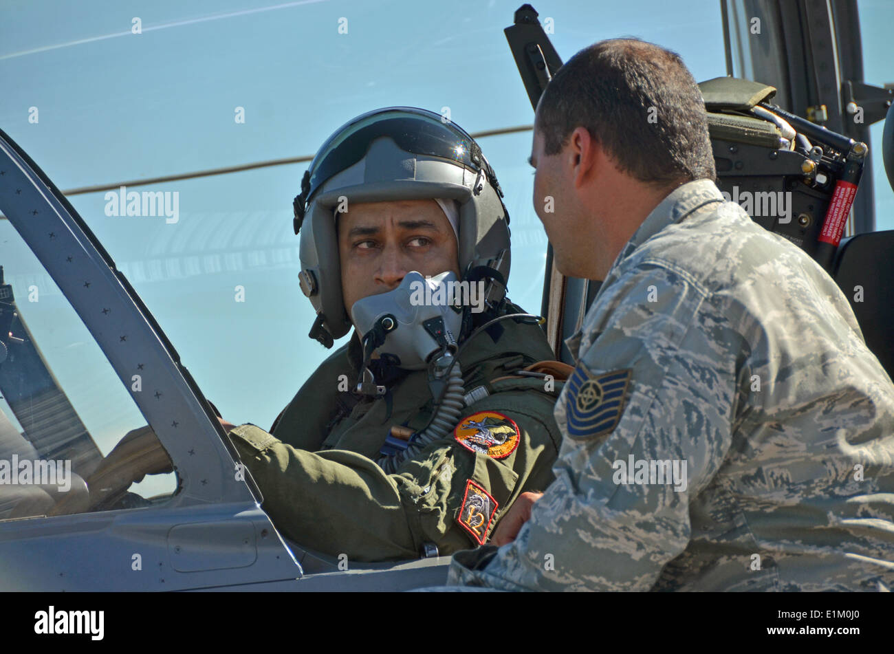 A Dominican air force pilot and crew chief conduct preflight checks on ...