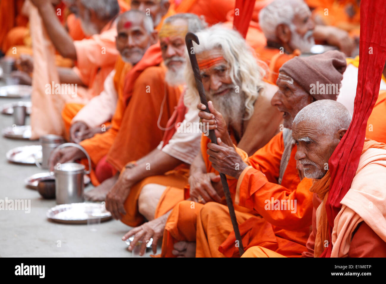 Sadhus waiting for a meal to be served in a dharamsala Stock Photo - Alamy