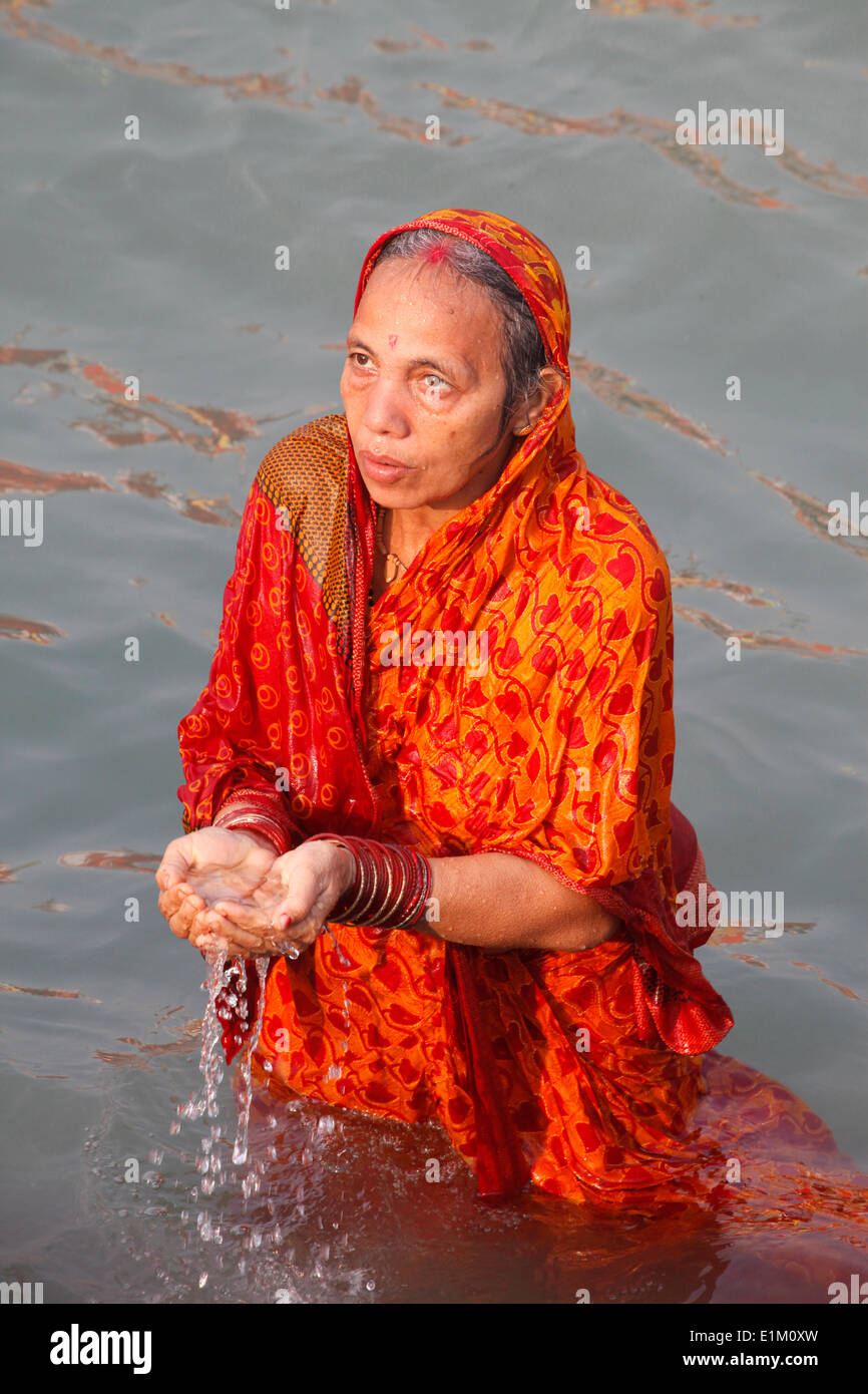 Hindu devotee bathing and praying in the river Ganges on the occasion ...