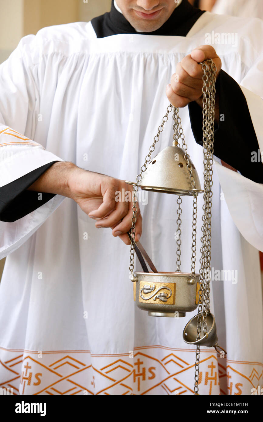 Holy mass in Palestine Altar boy preparing incense Stock Photo - Alamy
