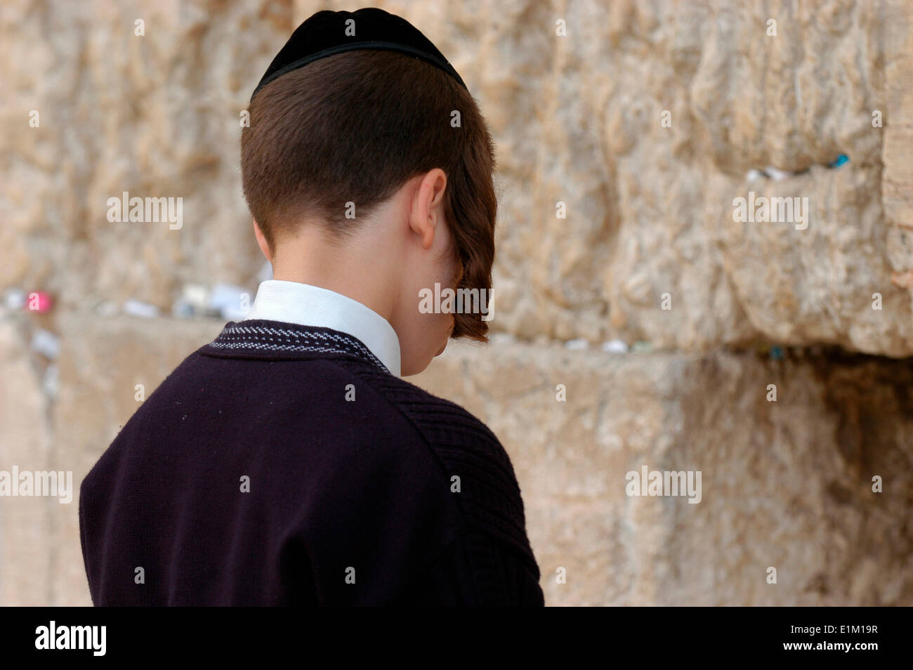 Orthodox Jewish child praying at the Kotel, also called Western Wall or ...