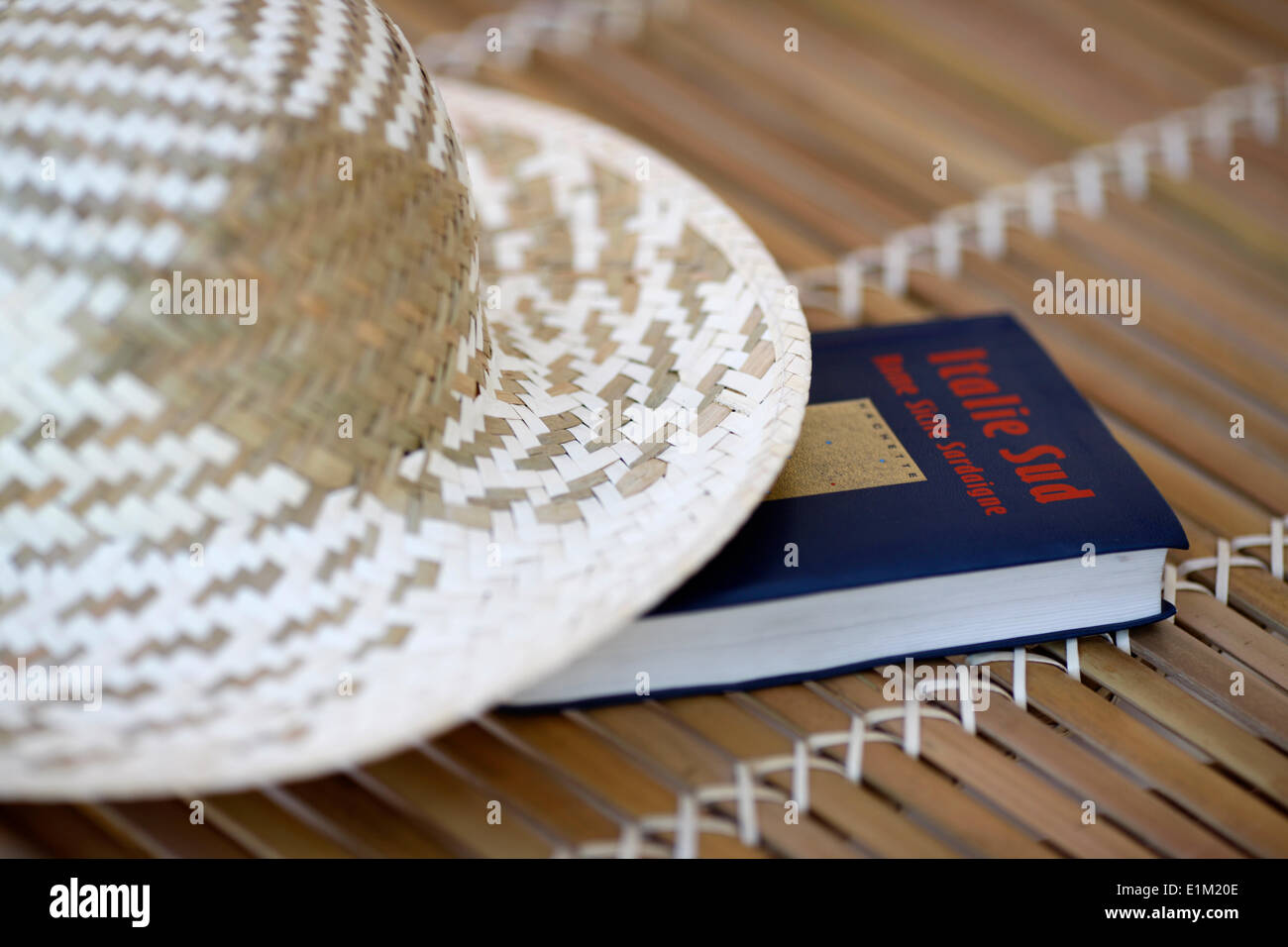 Straw hat & guidebook Stock Photo - Alamy