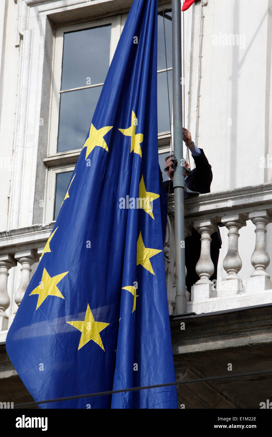 Man hoisting European flag Stock Photo - Alamy