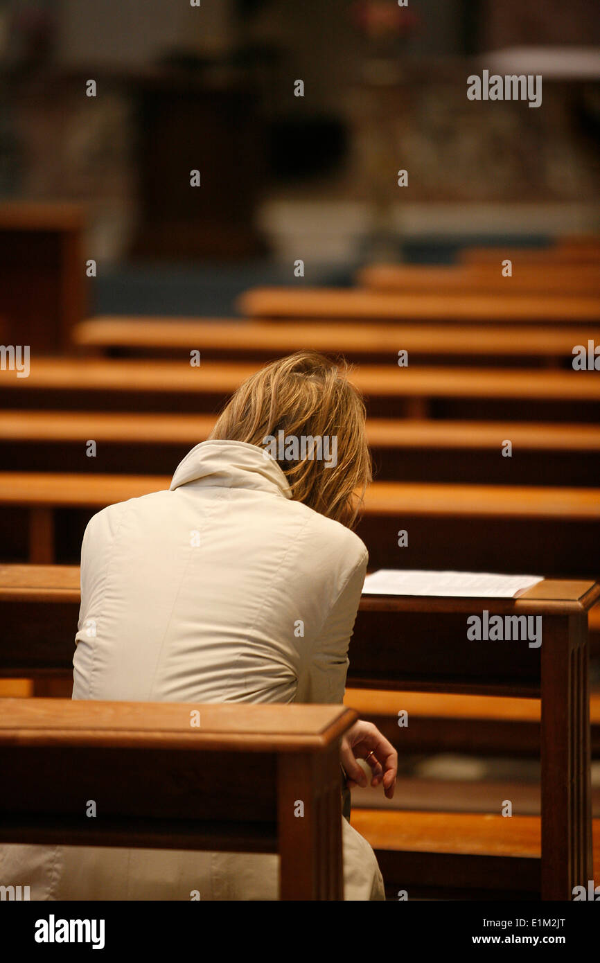 Woman praying in church hi-res stock photography and images - Alamy