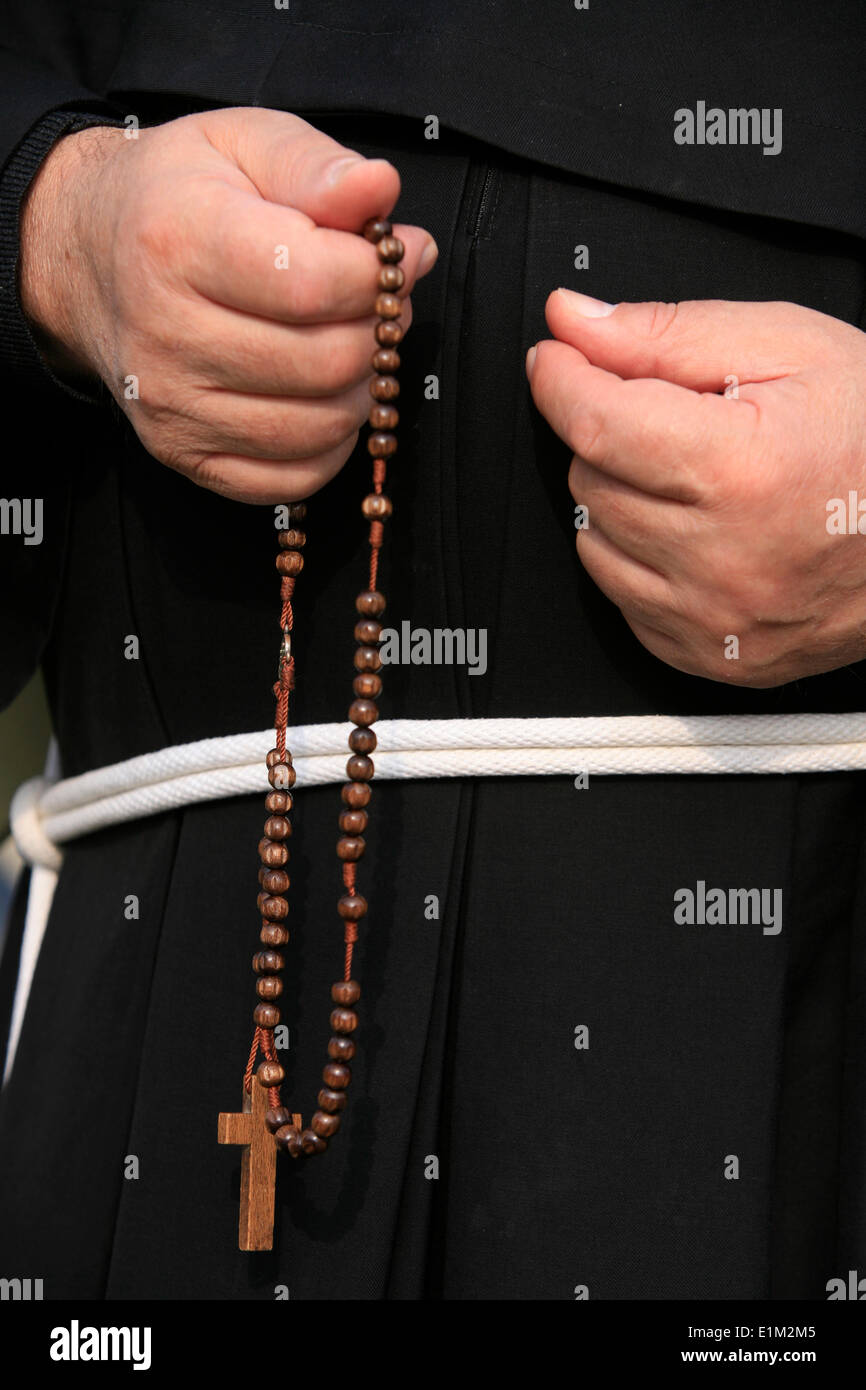Monk holding rosary Stock Photo - Alamy