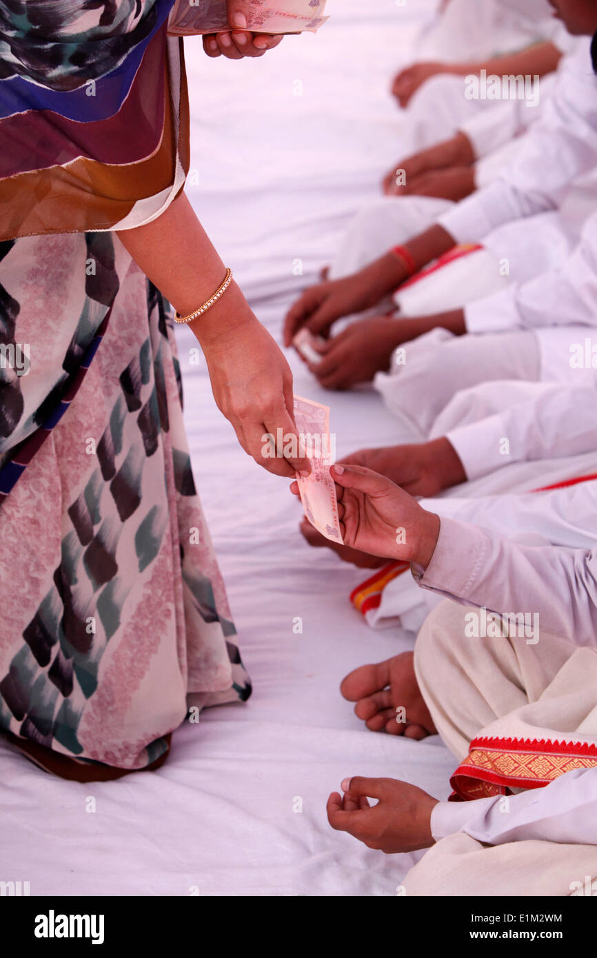 Brahmachari (Hindu temple students) receiving money offerings from a ...