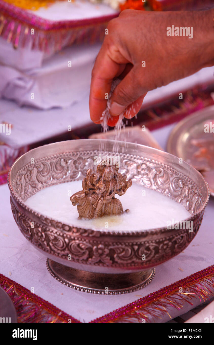Puja in a Hindu temple : rice offering to a statue of goddess Durga ...